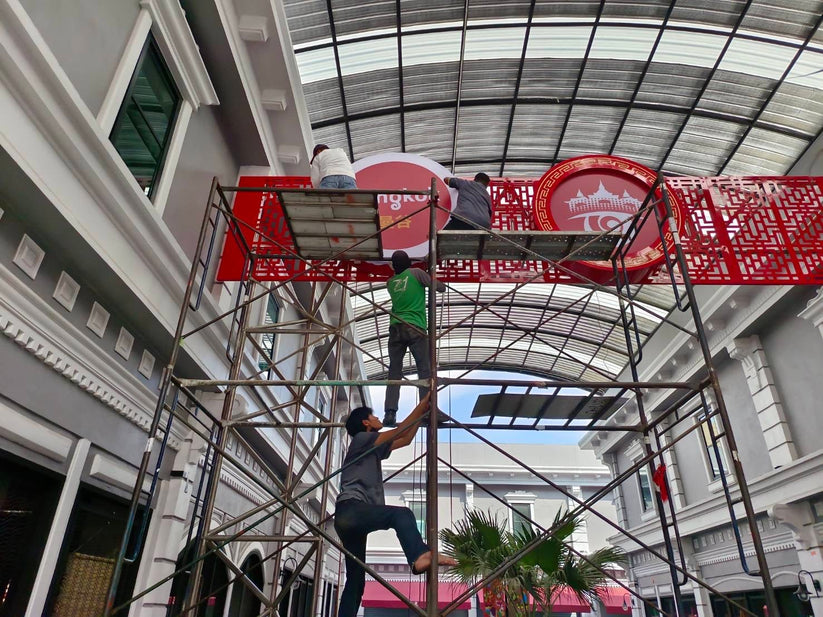 Install the sign by setting up scaffolding. performed with skill